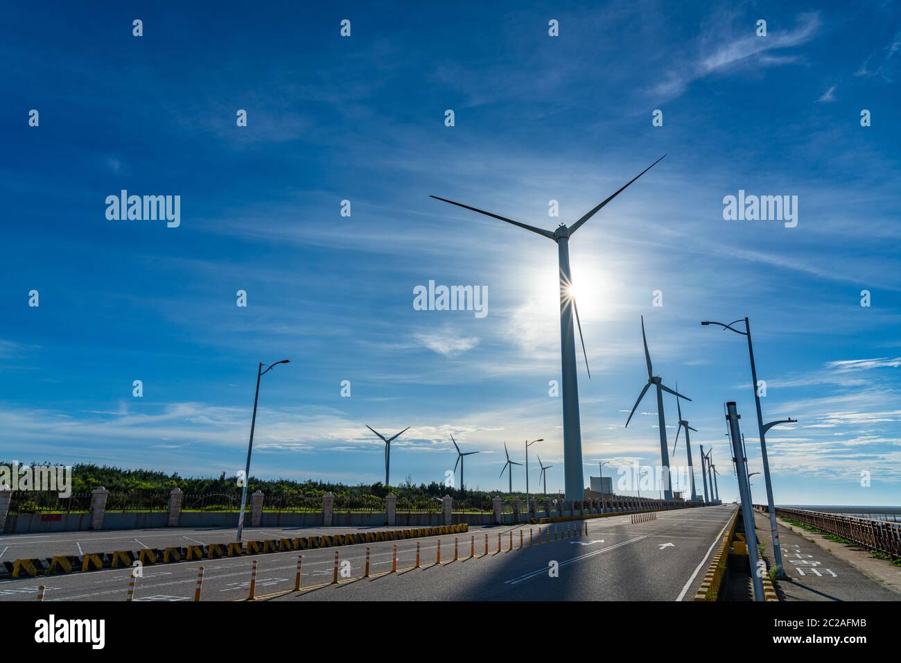 Gaomei Wetlands Area wind turbines in sunset time, a flat land which ...