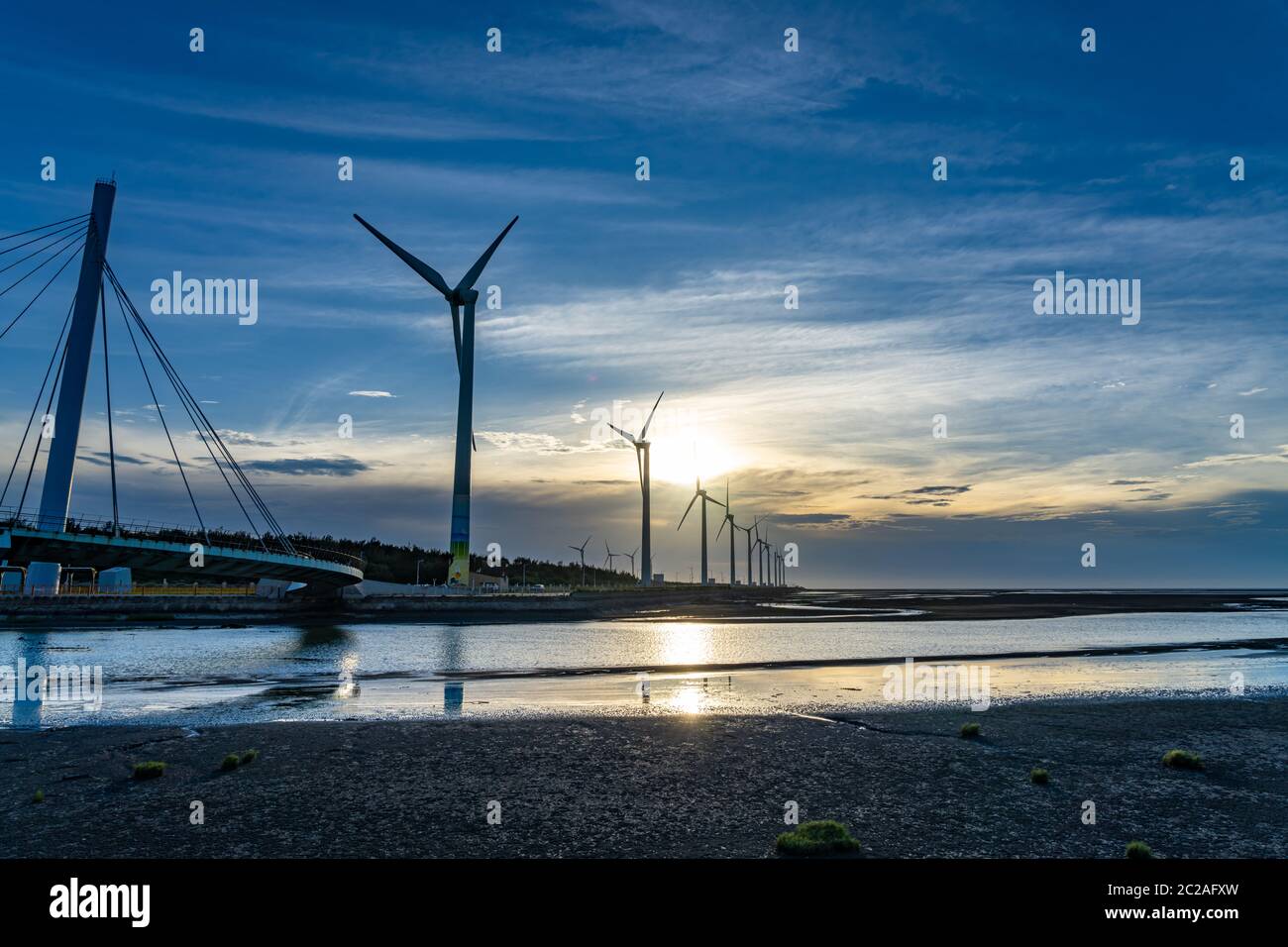 Gaomei Wetlands Area wind turbines in sunset time, a flat land which ...