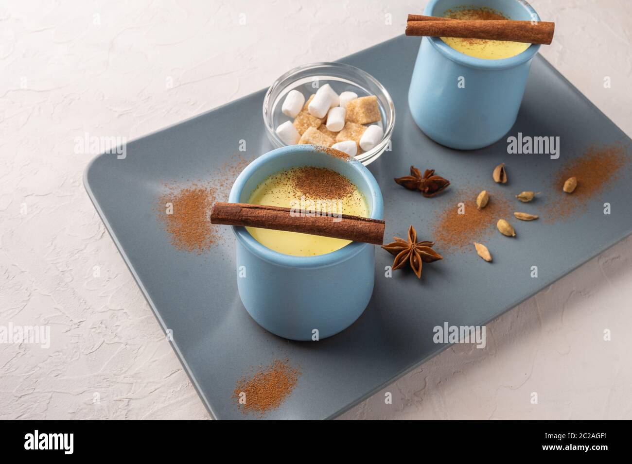 Two blue cups with traditional Indian masala chai tea with spices and ...