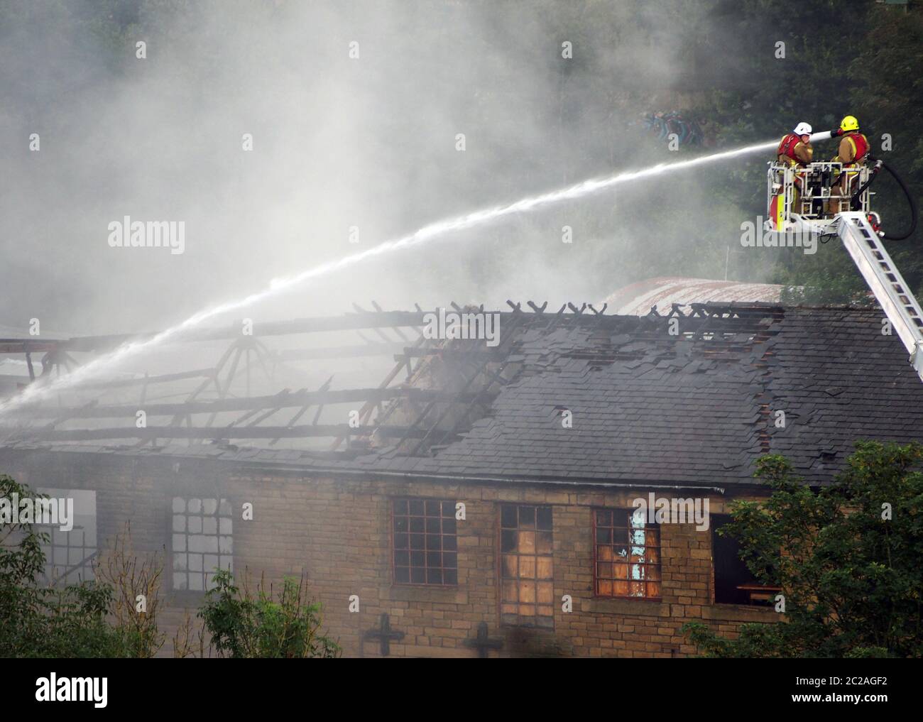 firemen on an elevated platform putting out the fire at the former ...
