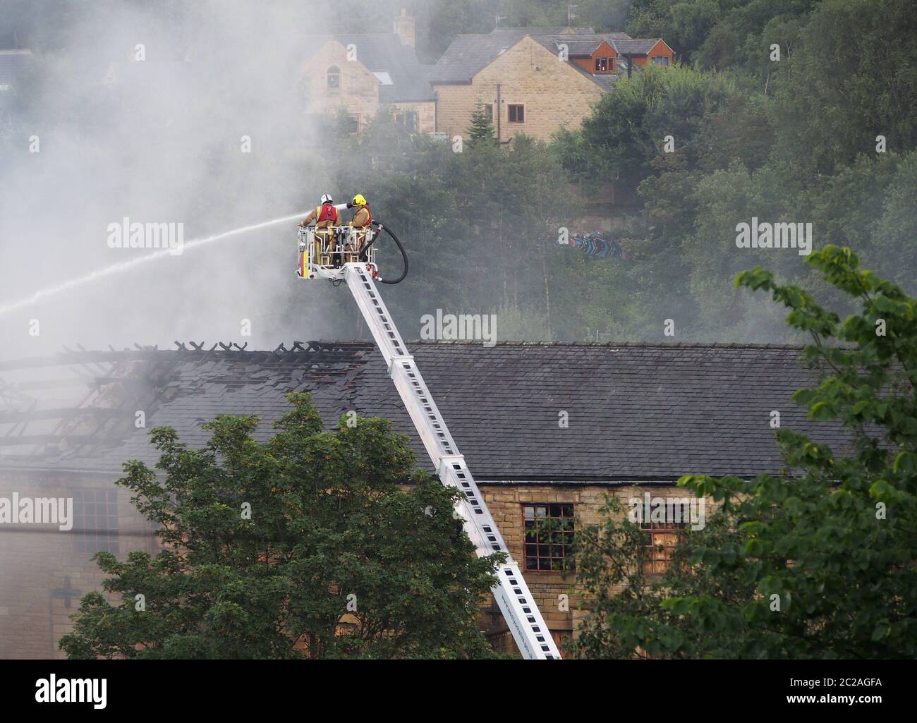 firemen on an elevated platform putting out the fire at the former ...