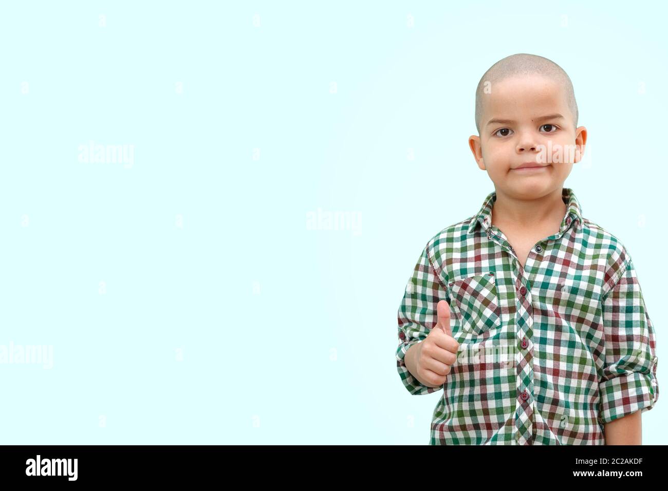 The boys hand shows a gesture of approval. Thumbs up. The hand shows ...