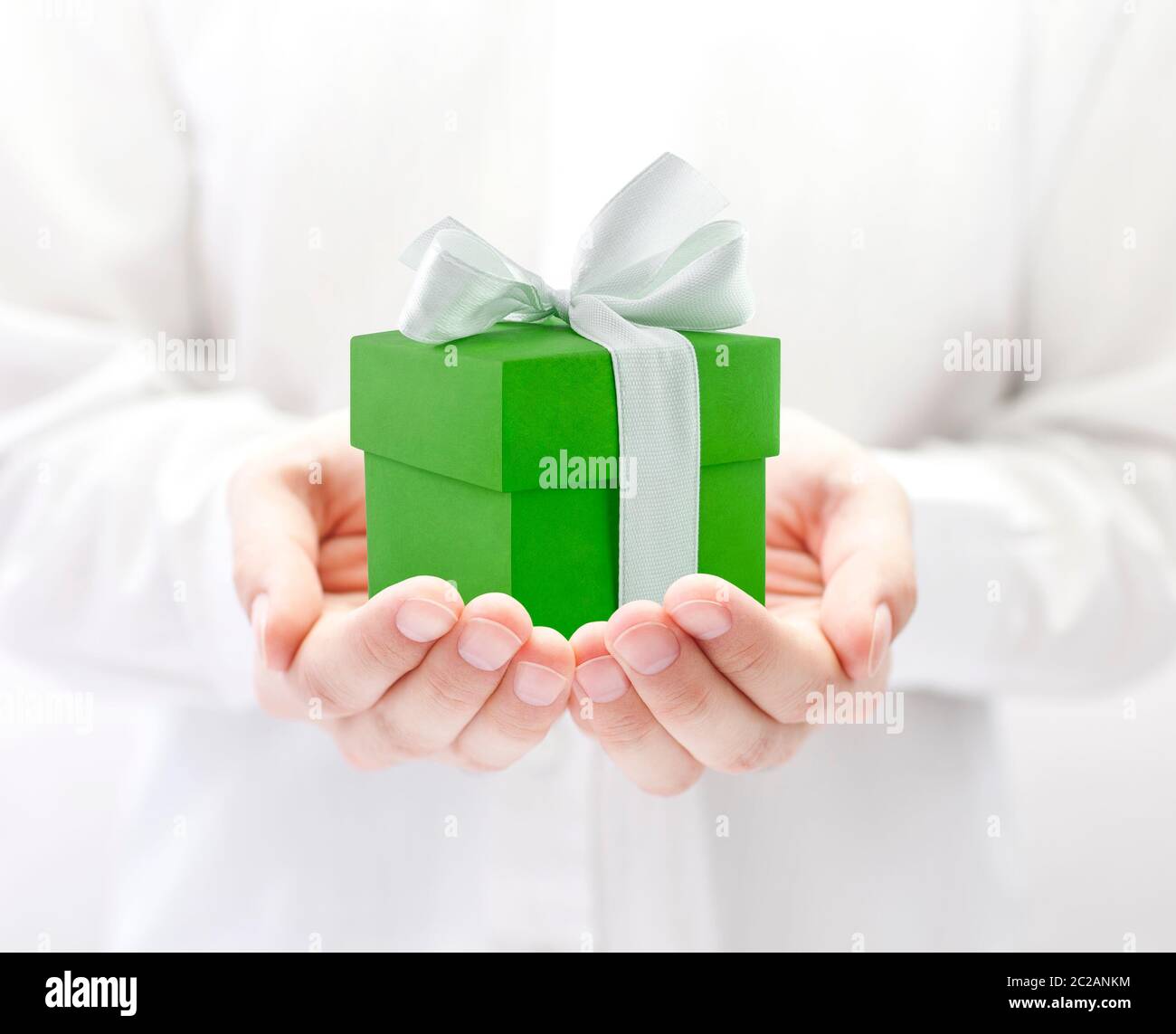 Small green present box in hands Stock Photo - Alamy