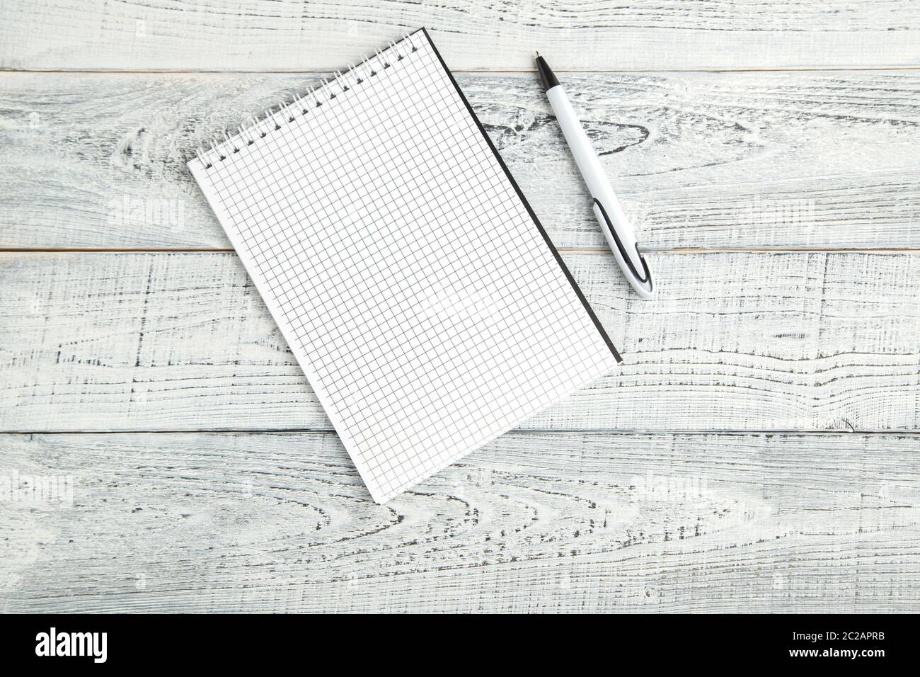 white paper Notepad and white pen on vintage shabby white wooden ...