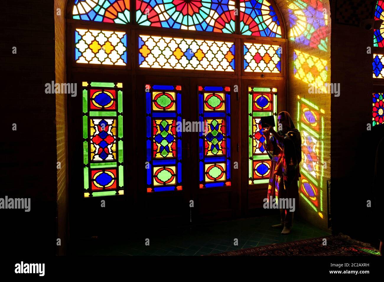 Morning light enter through the colorful glasswork windows of the ...