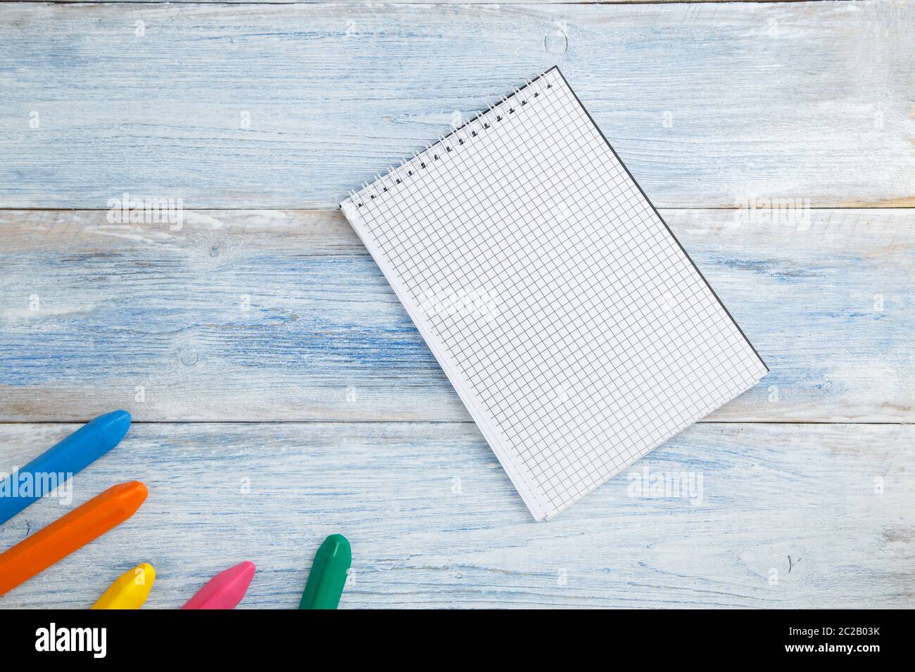 school children's concept. colored pencils or crayons and Notepad on a ...
