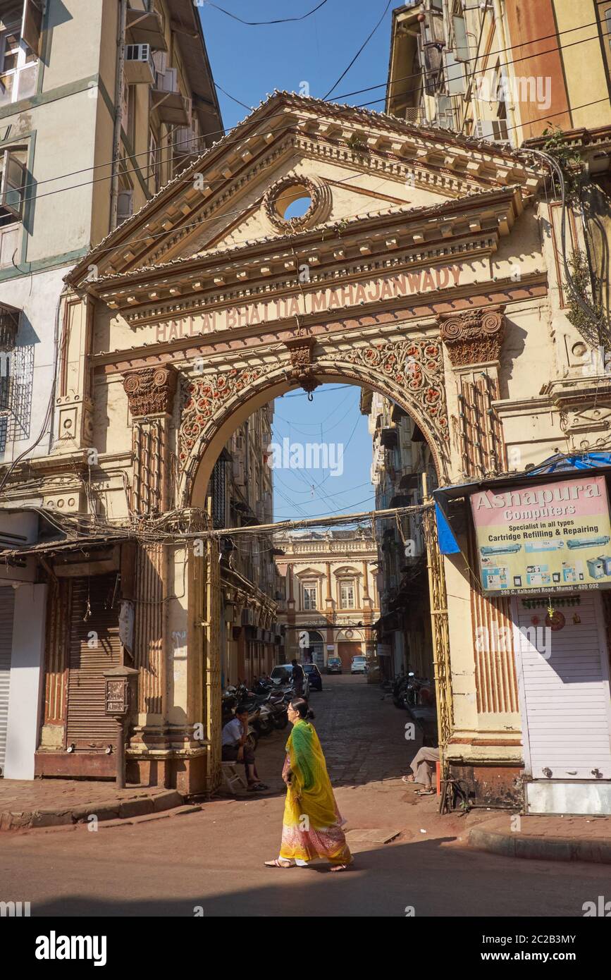 A woman passes the gate of Hallai Bhattia Mahajanwady, a housing ...