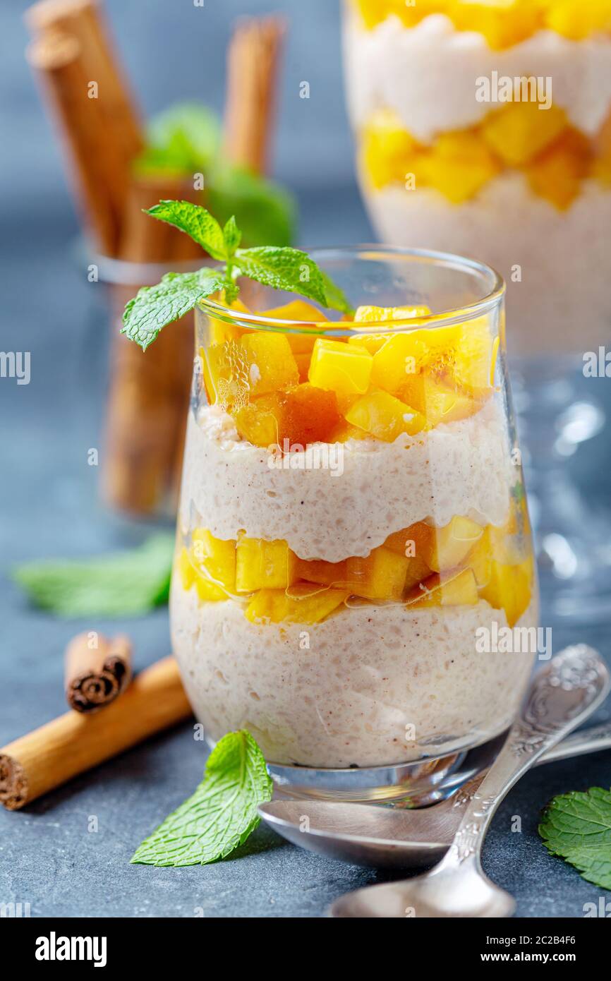 Rice pudding with peach slices and spices Stock Photo - Alamy