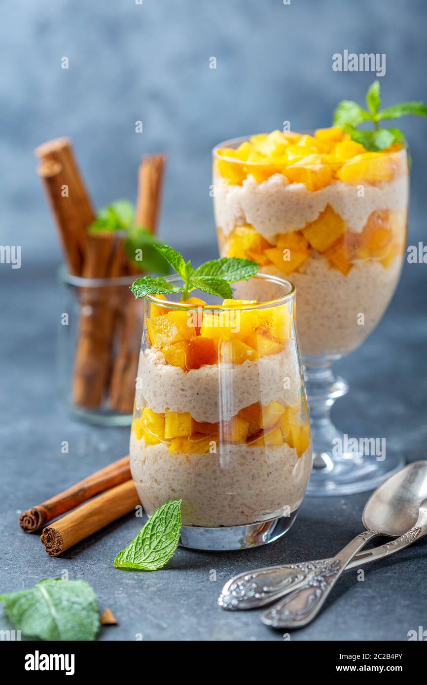 Rice pudding with peach slices for breakfast Stock Photo - Alamy