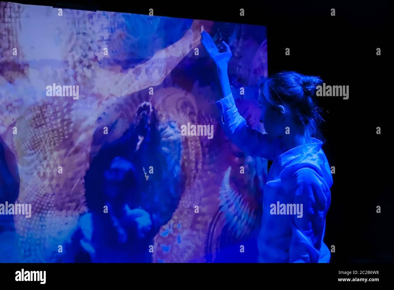 Large screen augmented reality experience - woman waving arms and ...