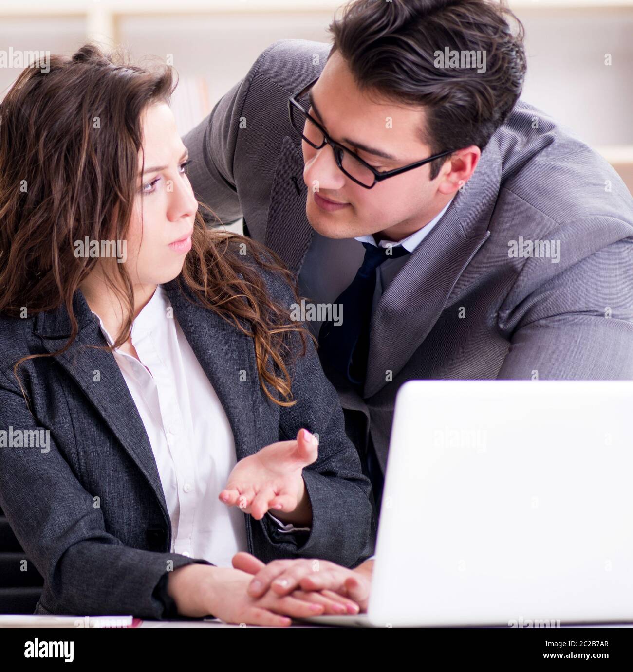 Unhappy boss having a chat with his secretary Stock Photo - Alamy