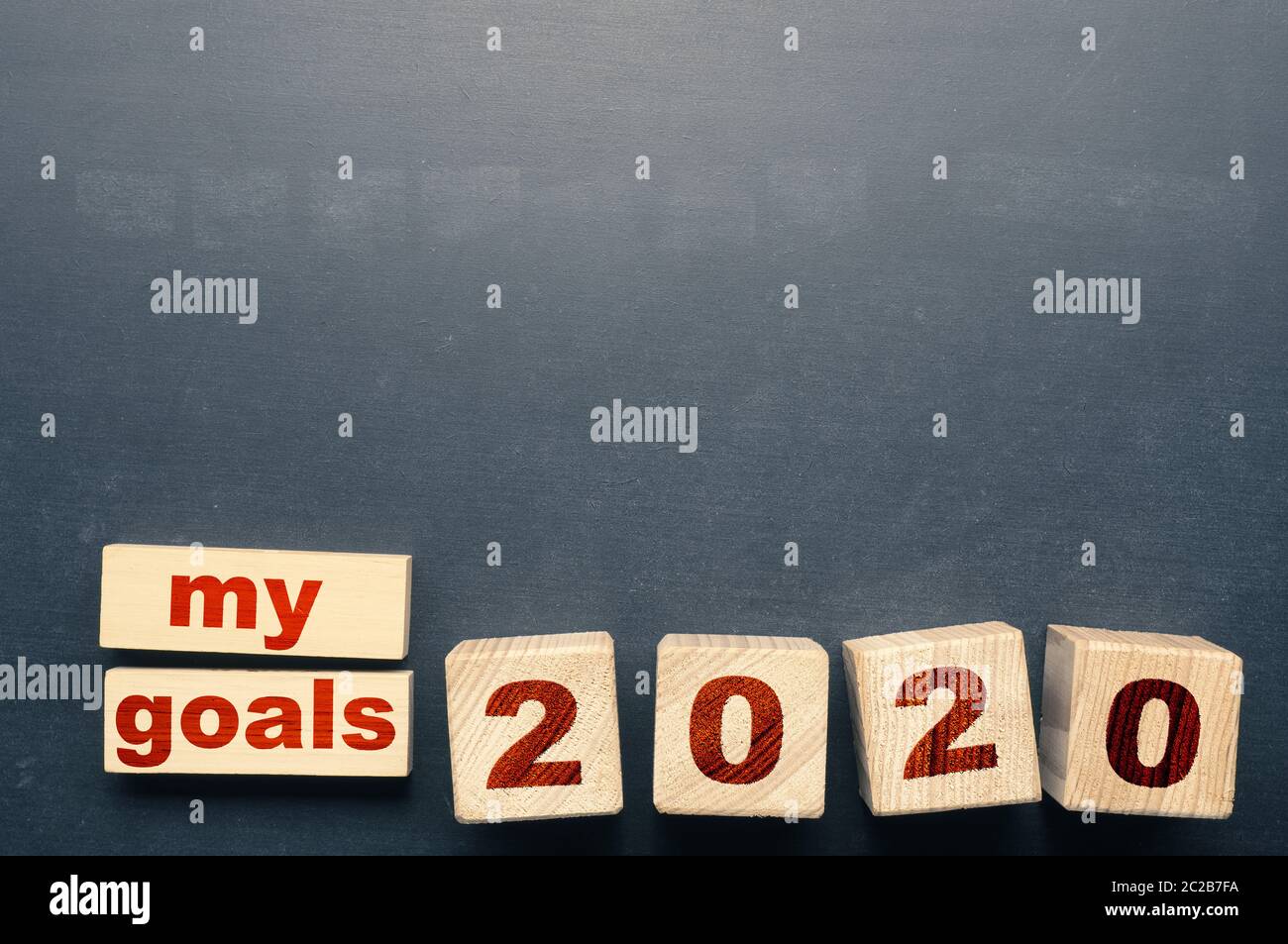 Wooden blocks with the words My golas 2020 on a chalkboard with space ...