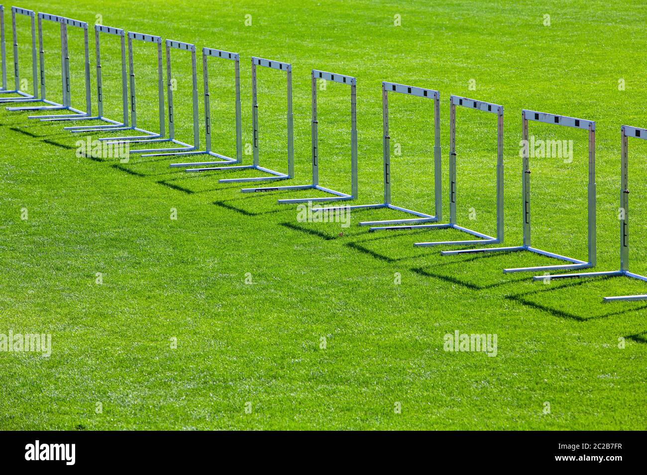 many hurdles standing on grass as a border Stock Photo - Alamy