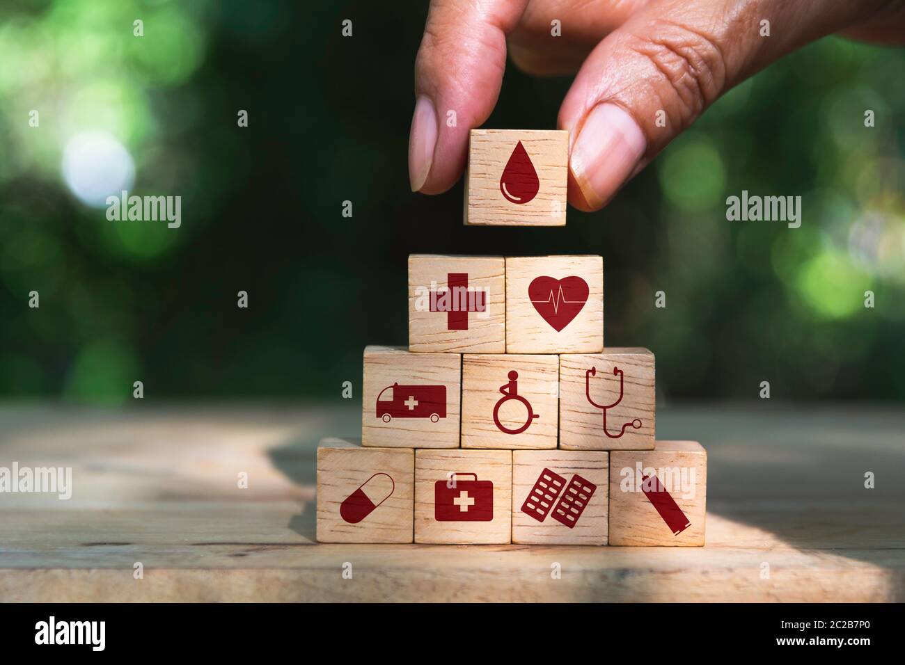 Hand holding cube dice health and medical symbols with copy space ...