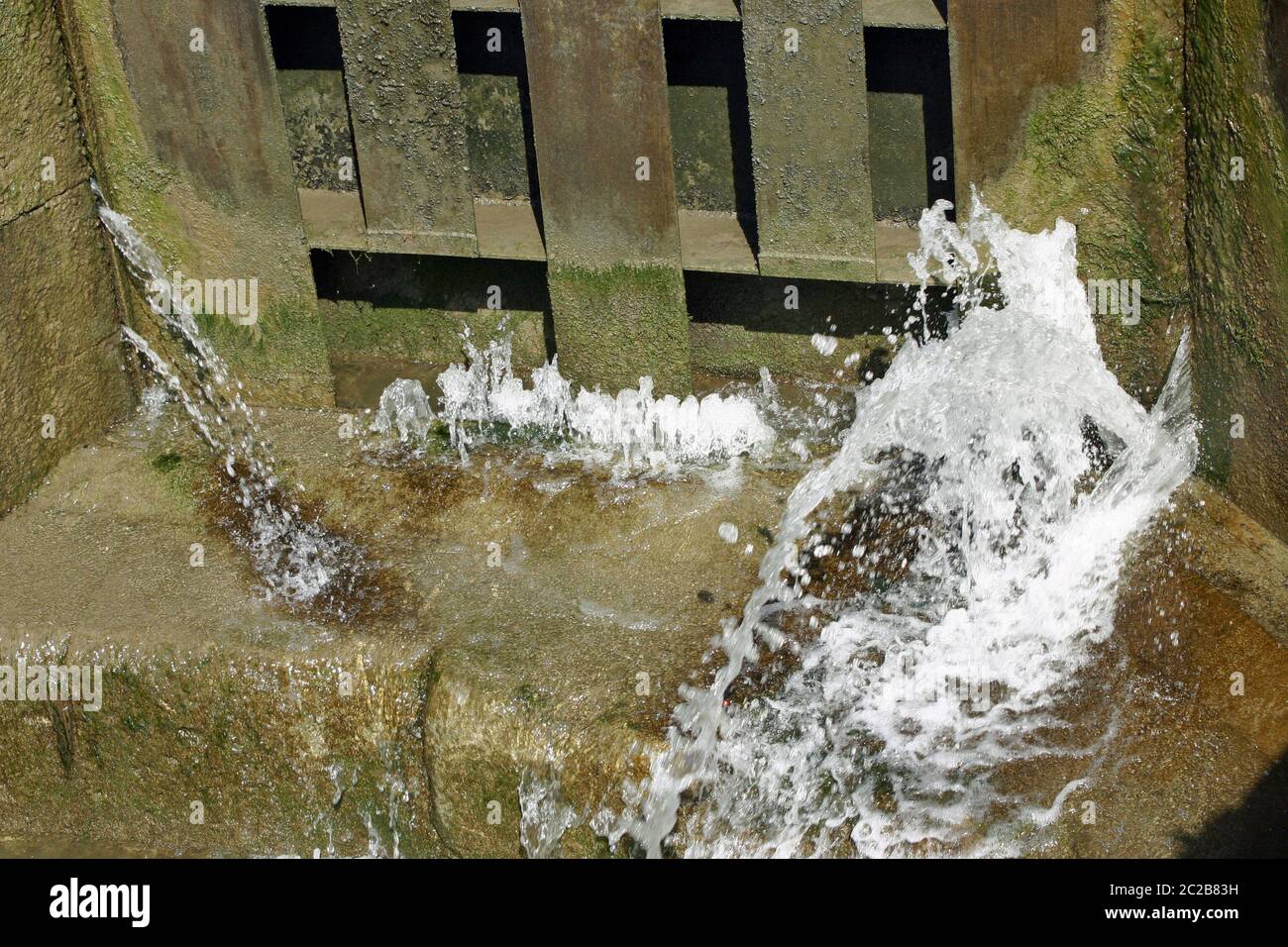 Leaking canal lock gate with water splashing out of the join between ...