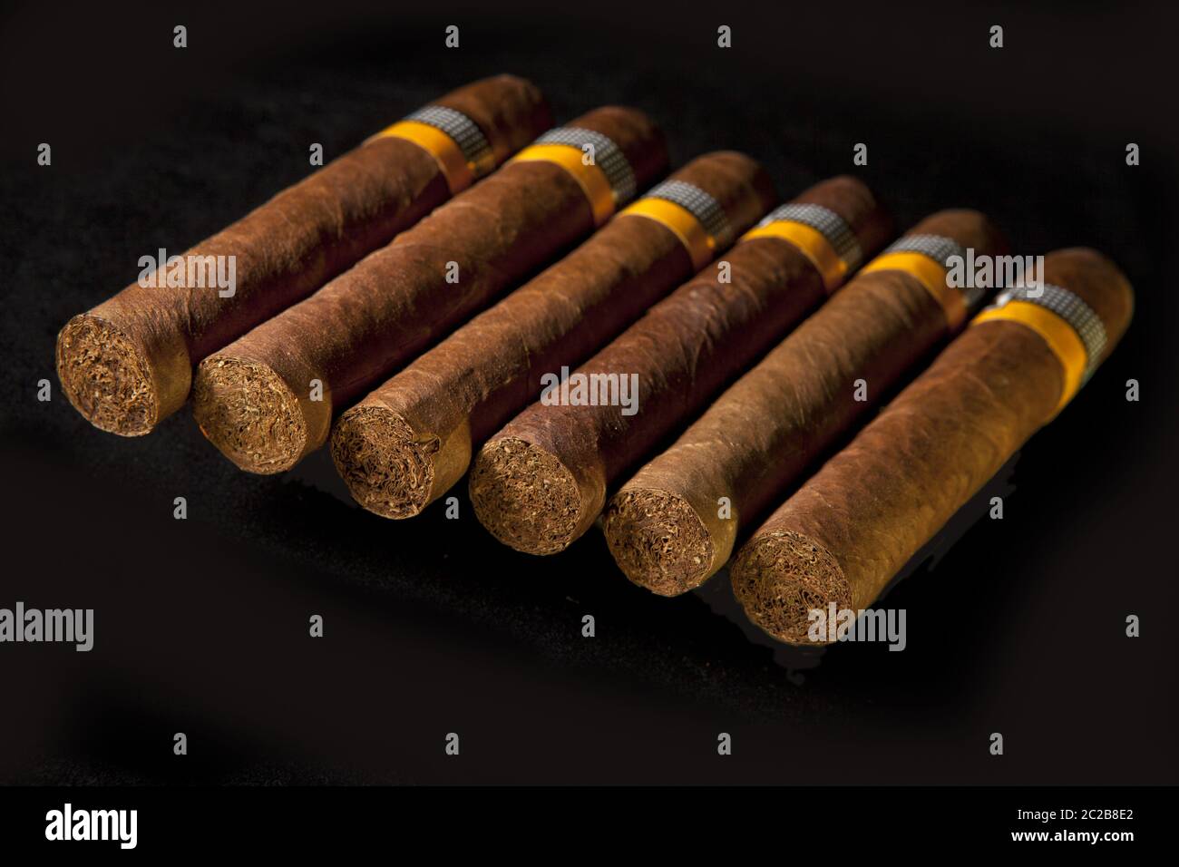 rolled cigars from a tobacco leaf on a black background, Small depth of ...