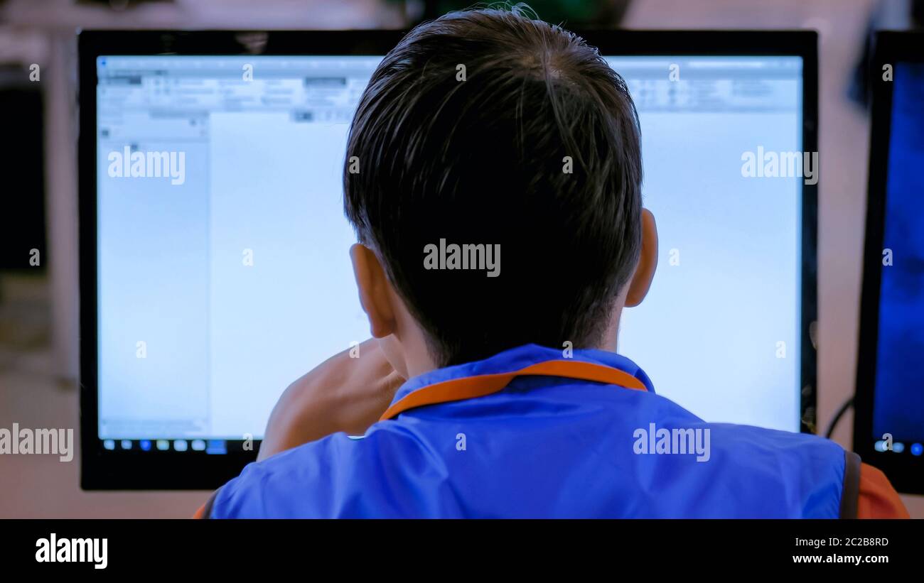 Back view - professional young male architect looking at display and ...