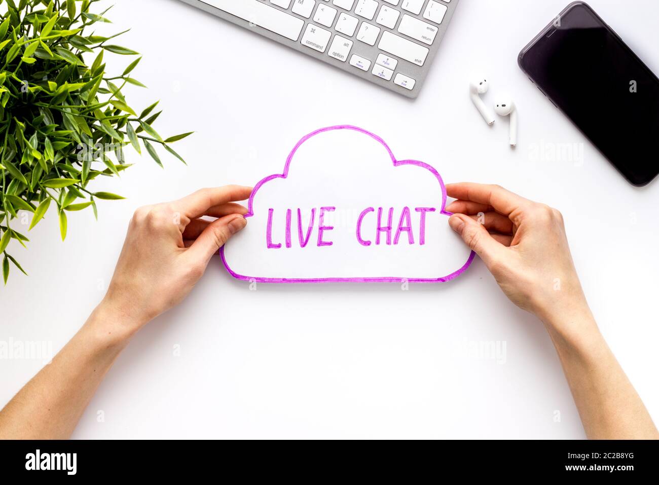 Live chat concept - bubble in hands on white desk top view Stock Photo ...