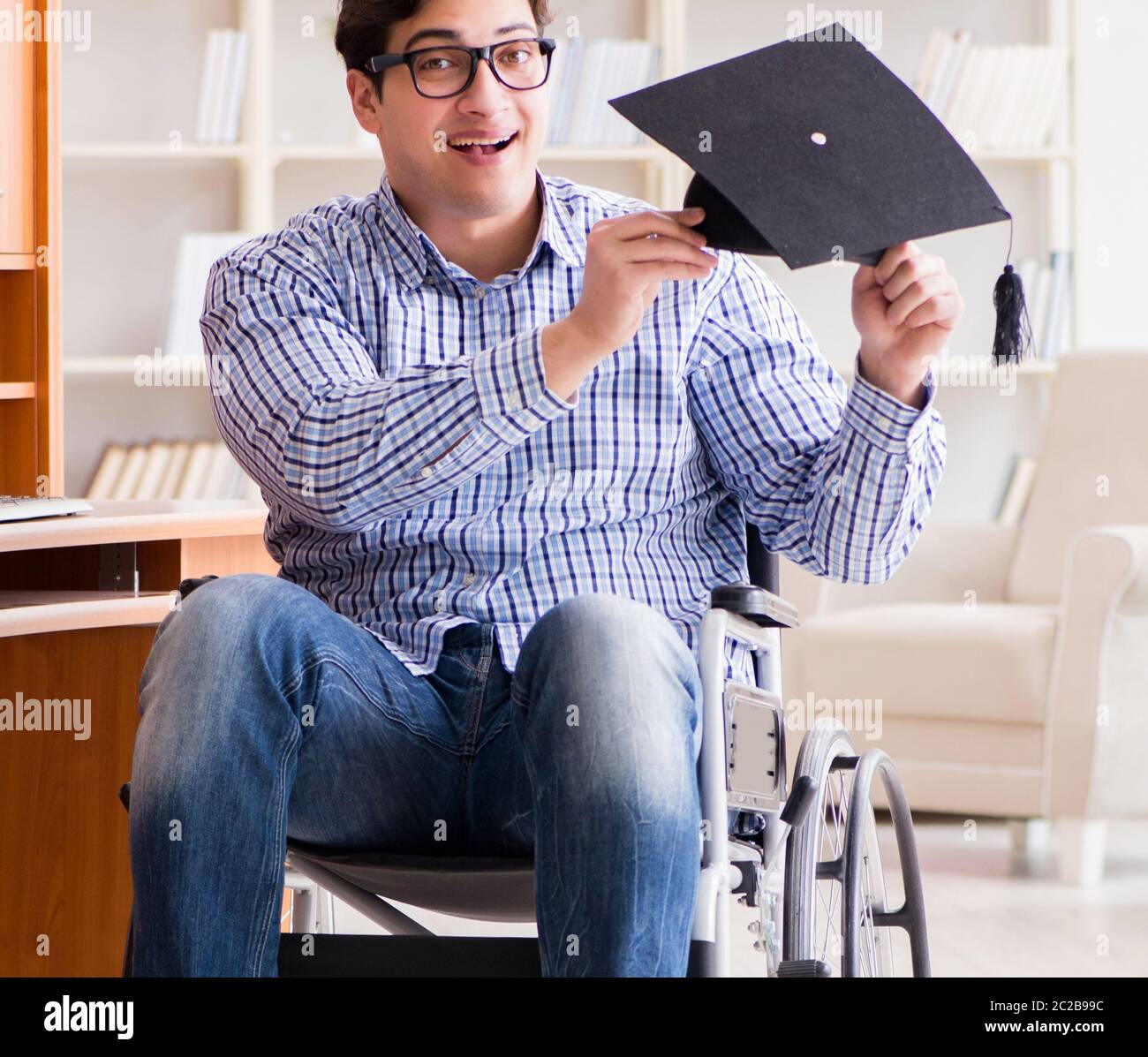 Disabled student studying at home on wheelchair Stock Photo - Alamy