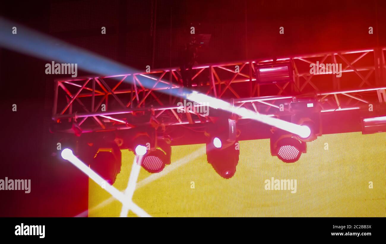 Colorful bright red concert lighting equipment for stage at nightclub ...