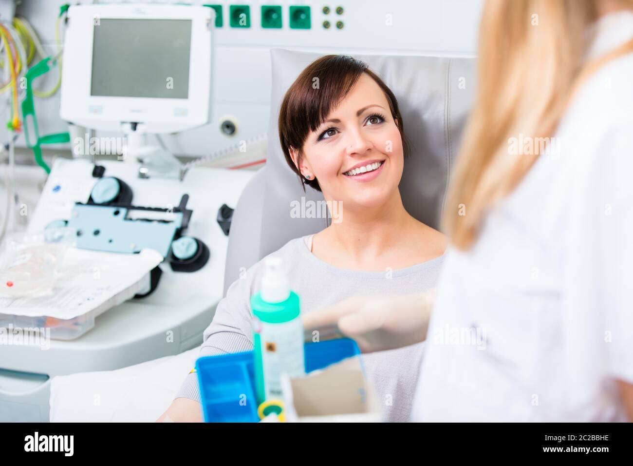Patient in ICU of hospital talking to doctor looking happy Stock Photo ...