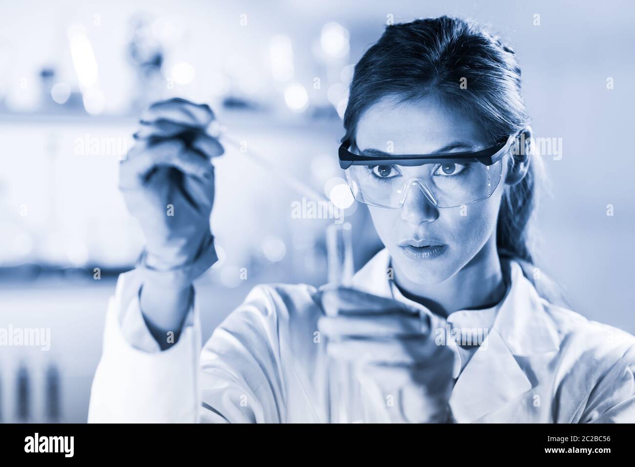 Life scientists researching in laboratory. Focused female life science ...