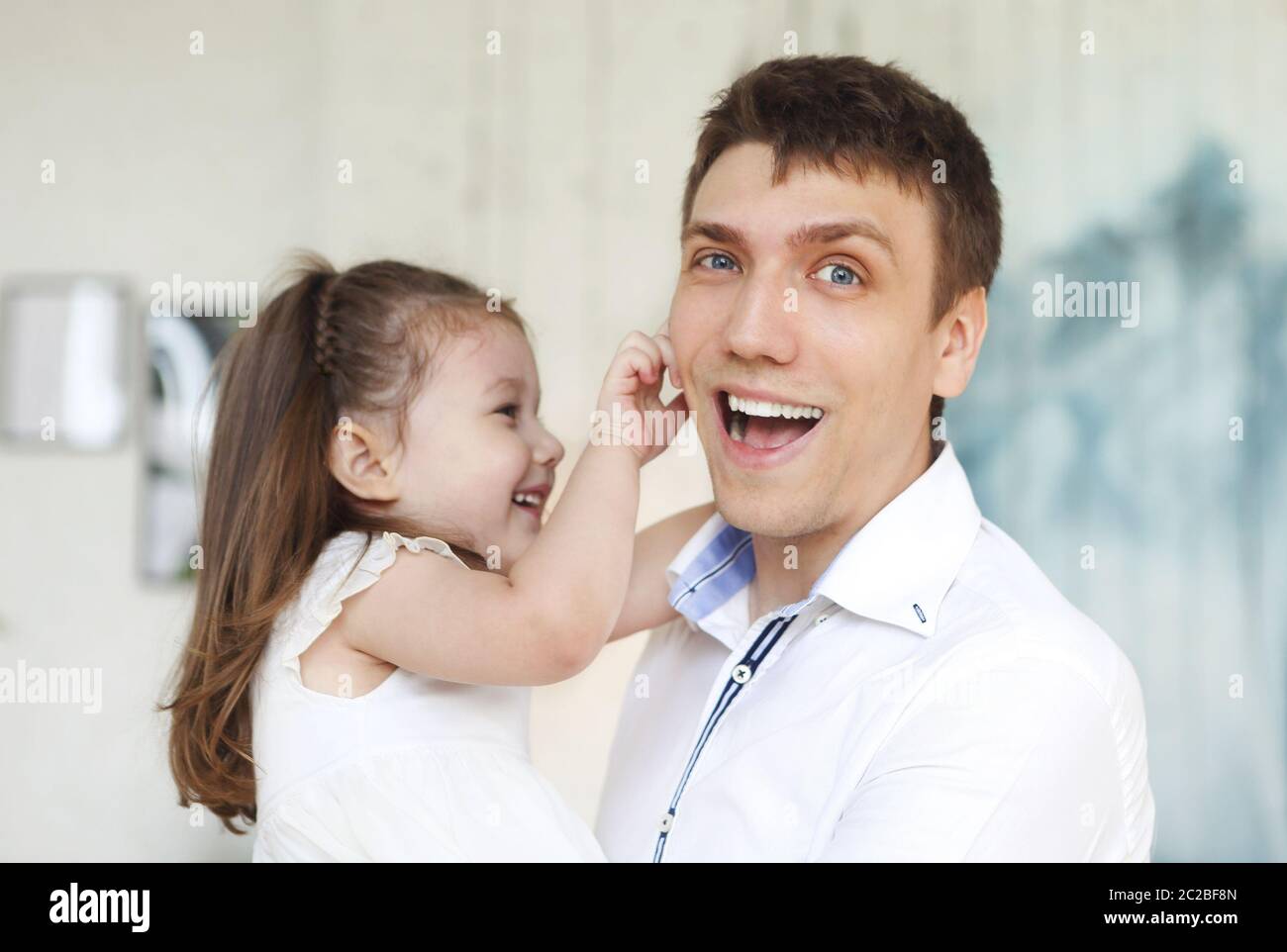 Adorable little daughter embracing father Stock Photo - Alamy Adorable little daughter embracing father Stock Photo - Alamy