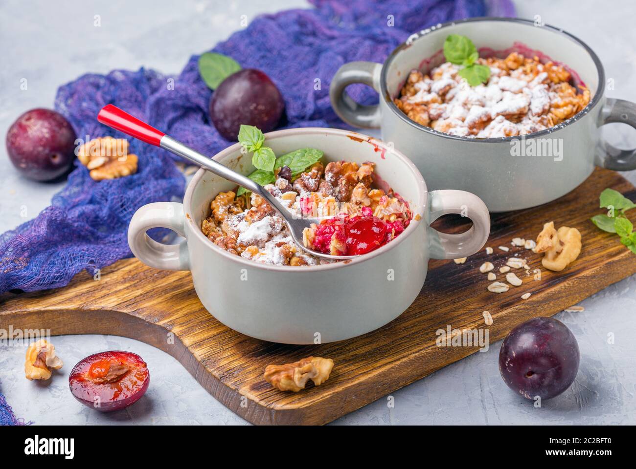 Red cherry plum crumble with walnut crumb Stock Photo - Alamy