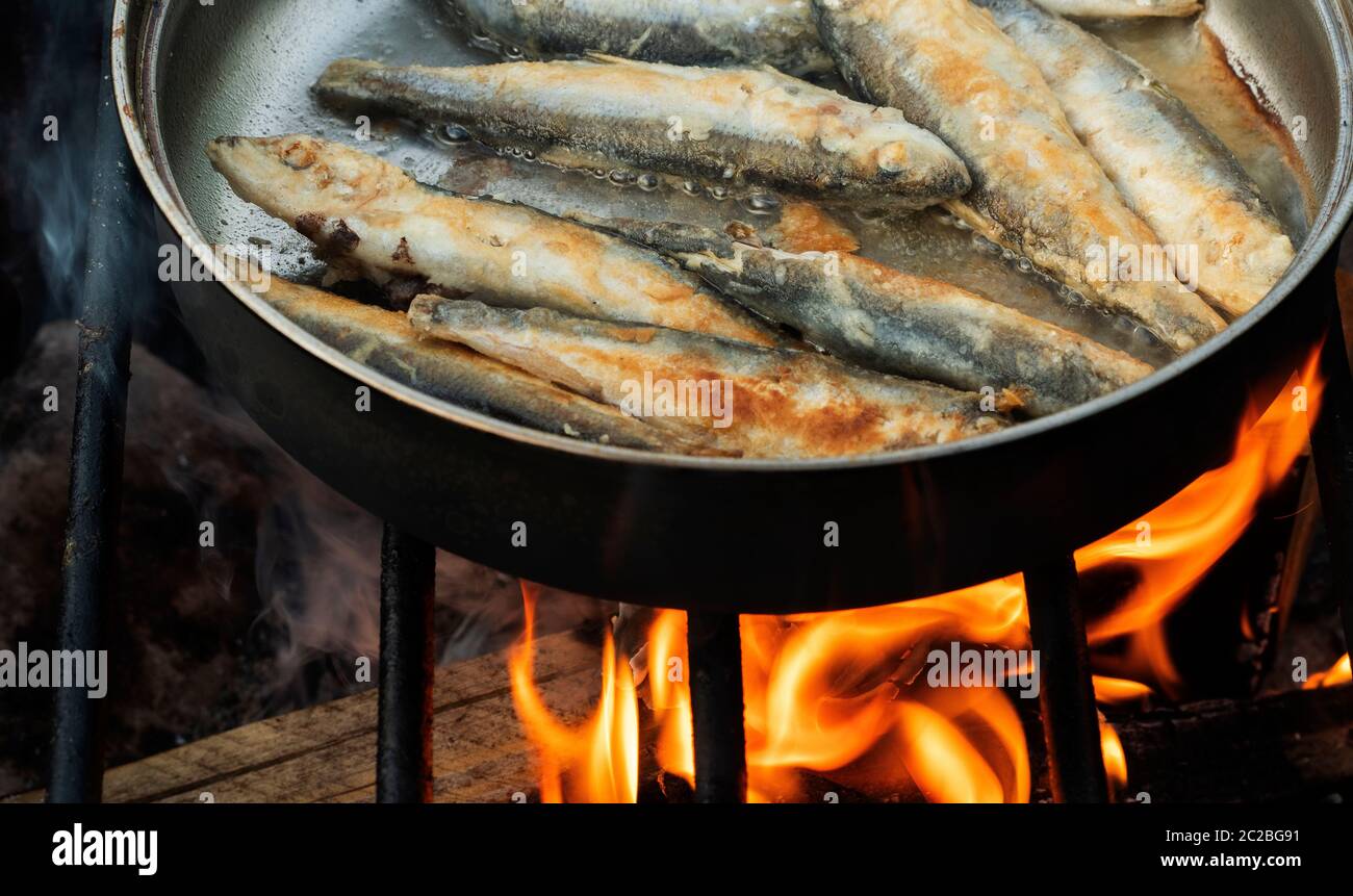 Atlantic herring is grilled in a pan Stock Photo - Alamy