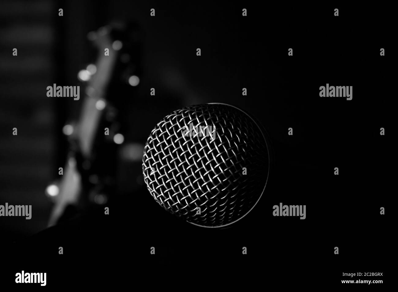 Microphone Closeup with Bass Guitar In The Background Stock Photo - Alamy