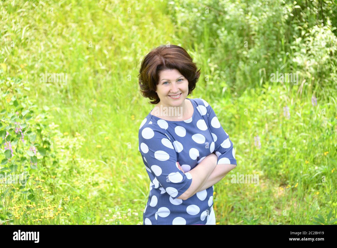 Portrait of a woman on background of green grass on a sunny day Stock ...