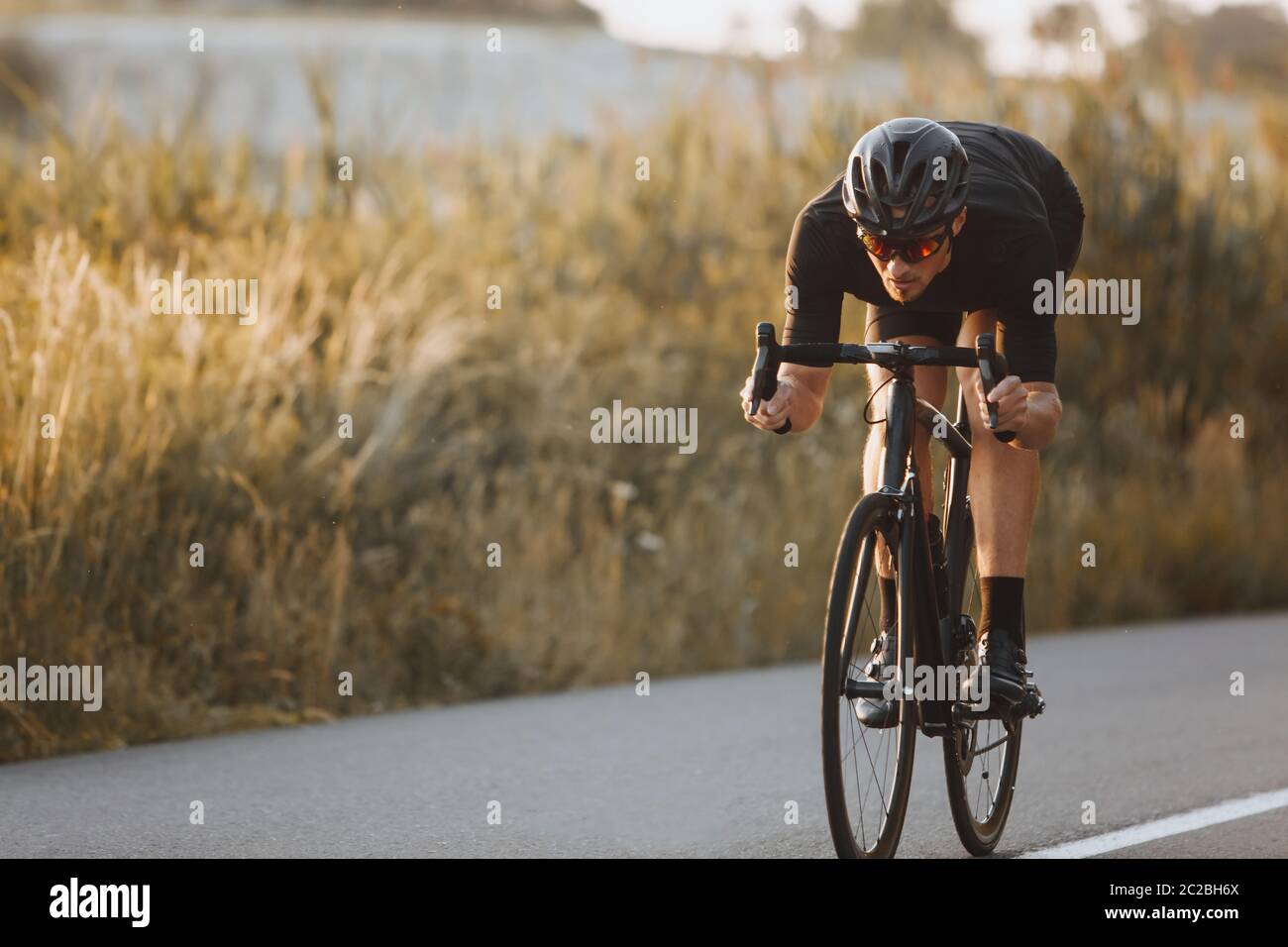 Active professional sportsman cyclist wearing black sports outfit ...