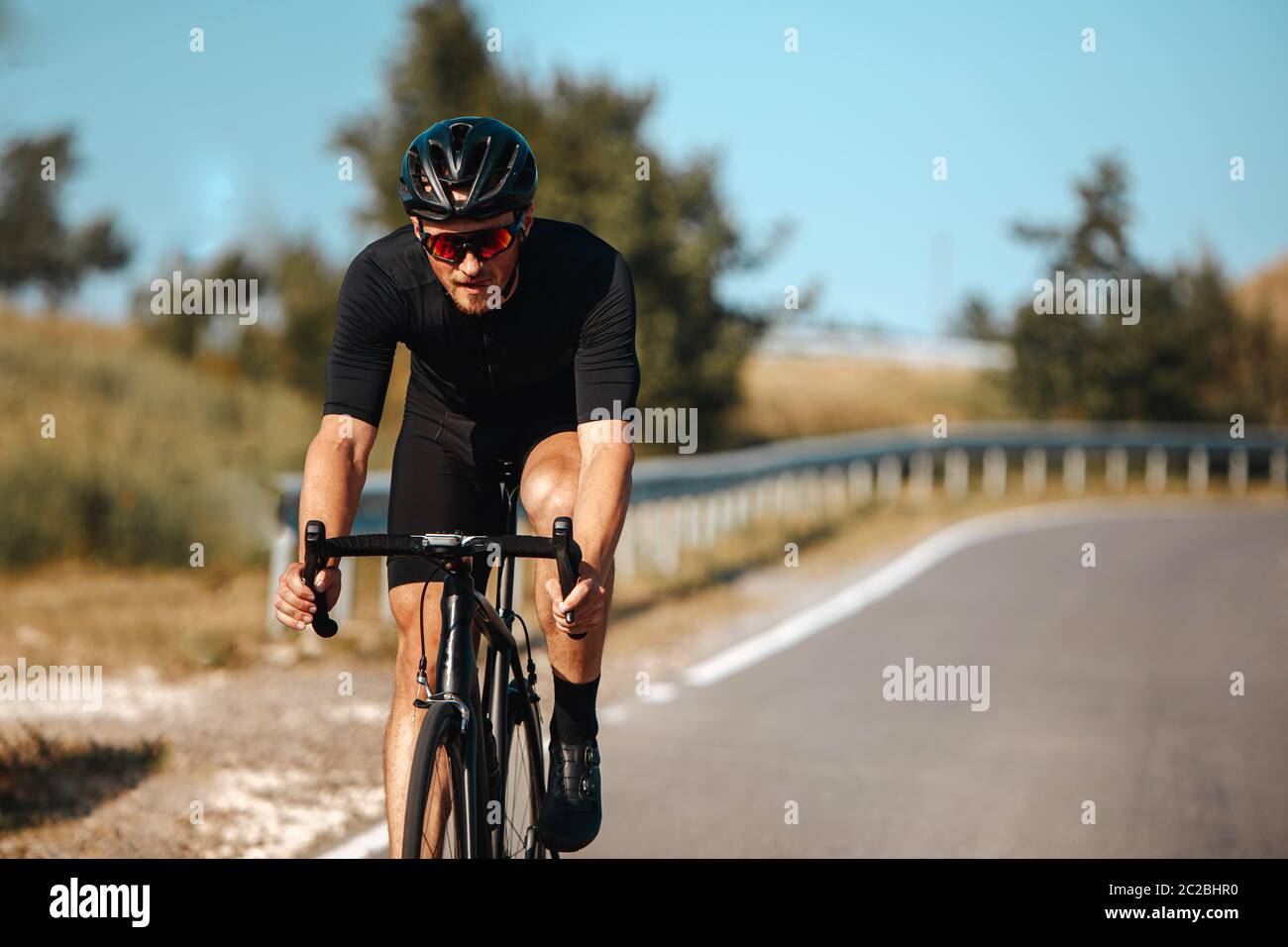 Front view of professional cyclist in sport outfit practising in ...