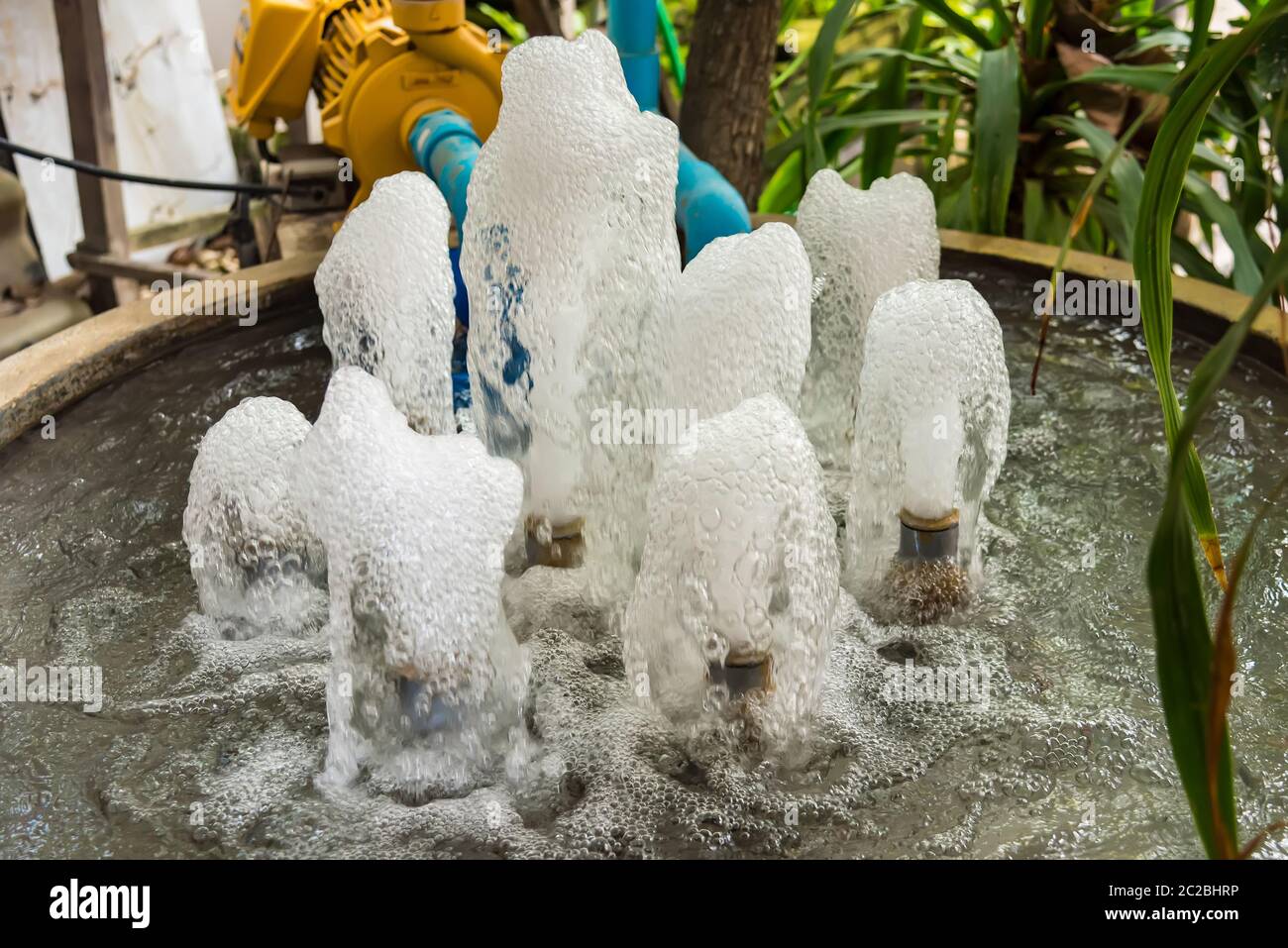 Small fountain at garden, Blue water flowing Stock Photo - Alamy