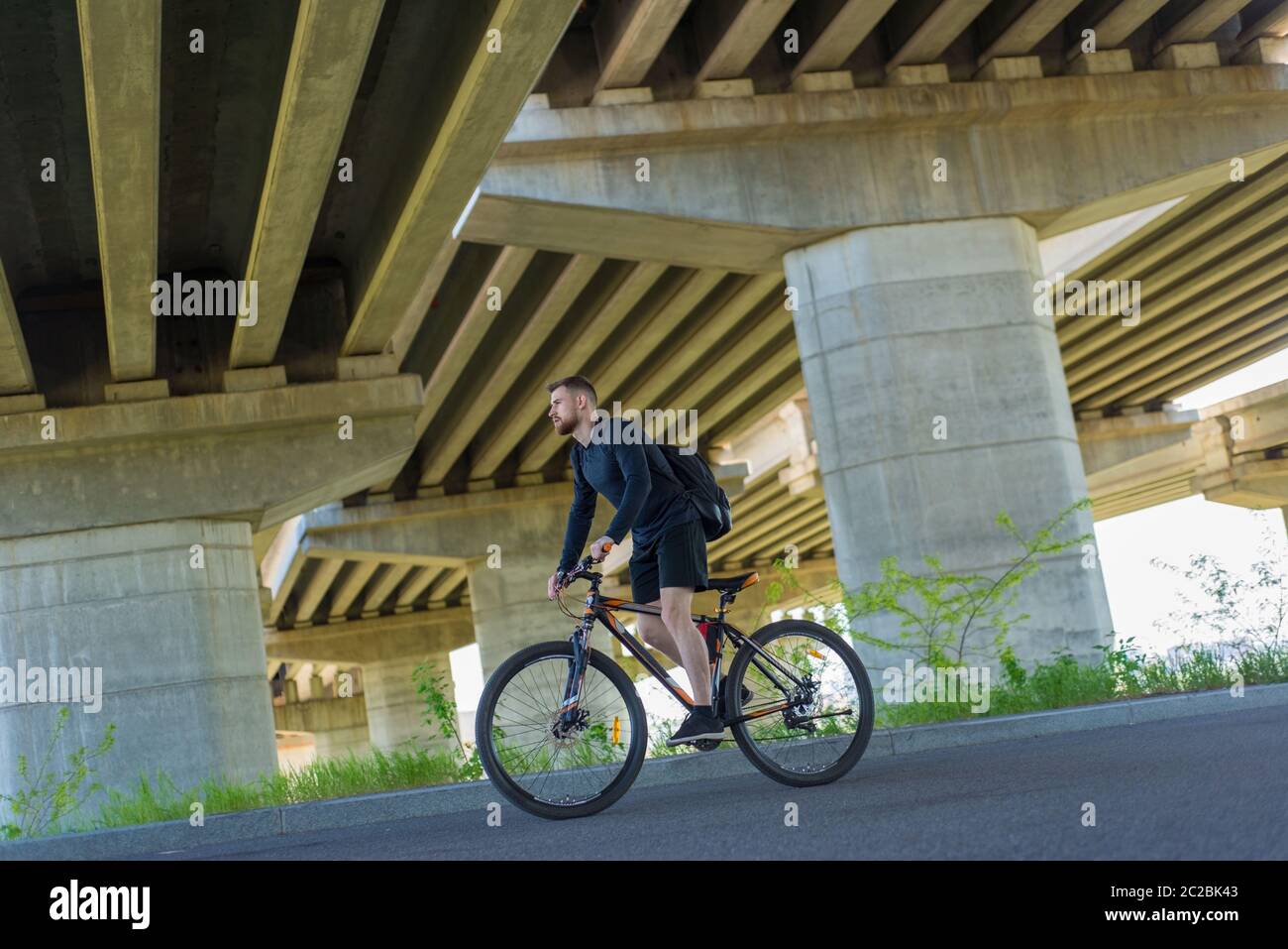 Cyclist riding under bridge hi-res stock photography and images - Alamy