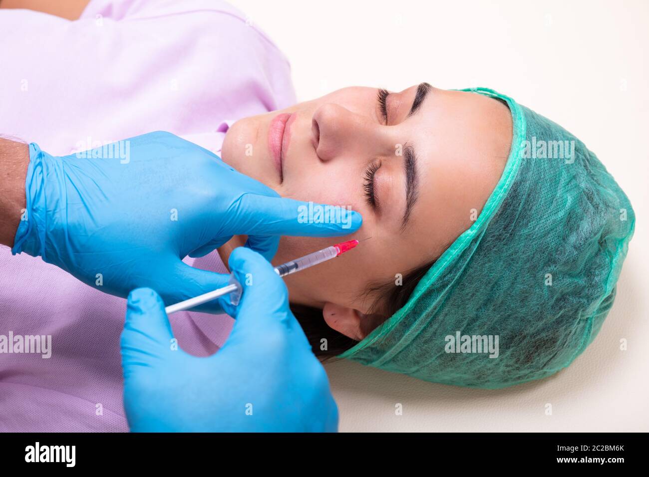 Top View Of Beautiful Young Woman Gets Beauty Injection In Eye Area ...