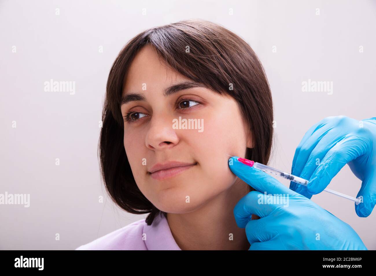 Beautiful Young Woman Getting Cosmetic Injection On Cheek Over The Face ...