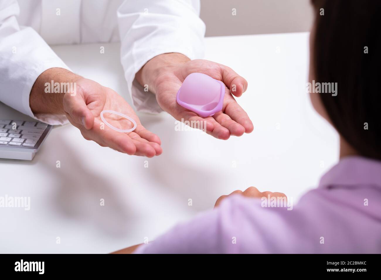 Gynecologist Showing Contraception Ring And Diaphragm To Woman And ...