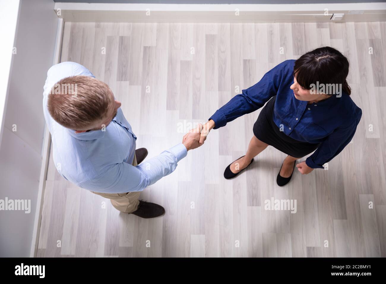 An Overhead View Of Business Partners Standing Over Hardwood Floor ...