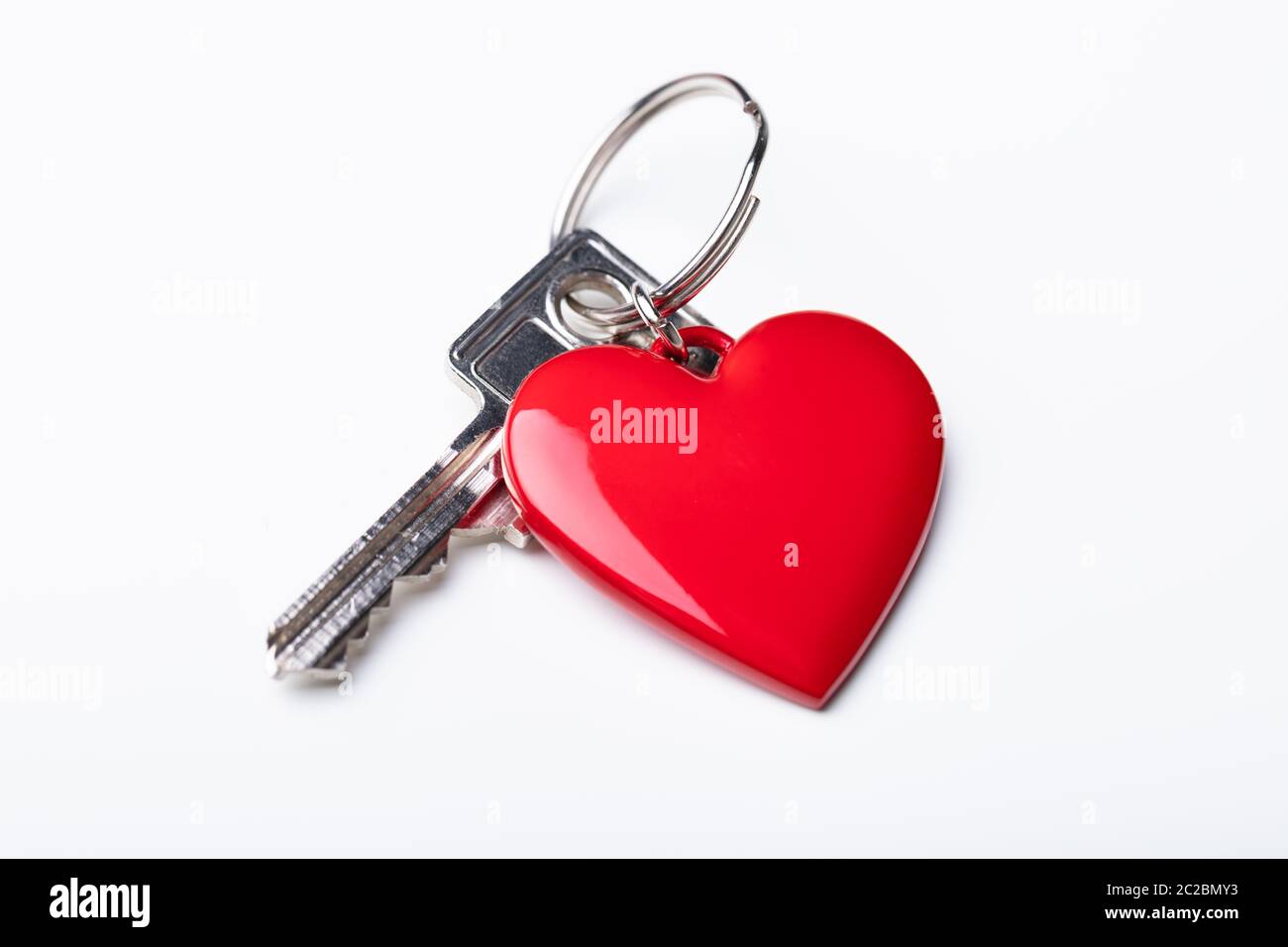 High Angle View Of Key With Red Heart Shape Key Chain Over White ...