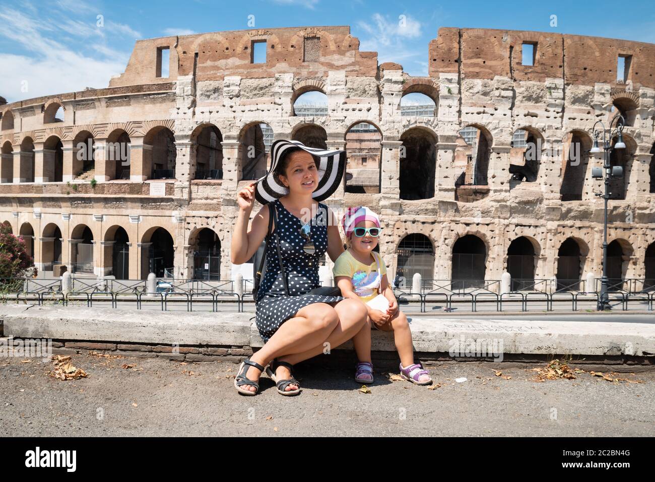 Young Mother And Daughter Sitting In Front Of Colosseum In Rome, Italy ...