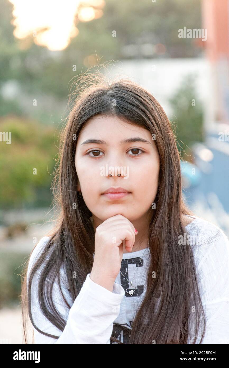 Young girl of 9 in deep thought Stock Photo - Alamy