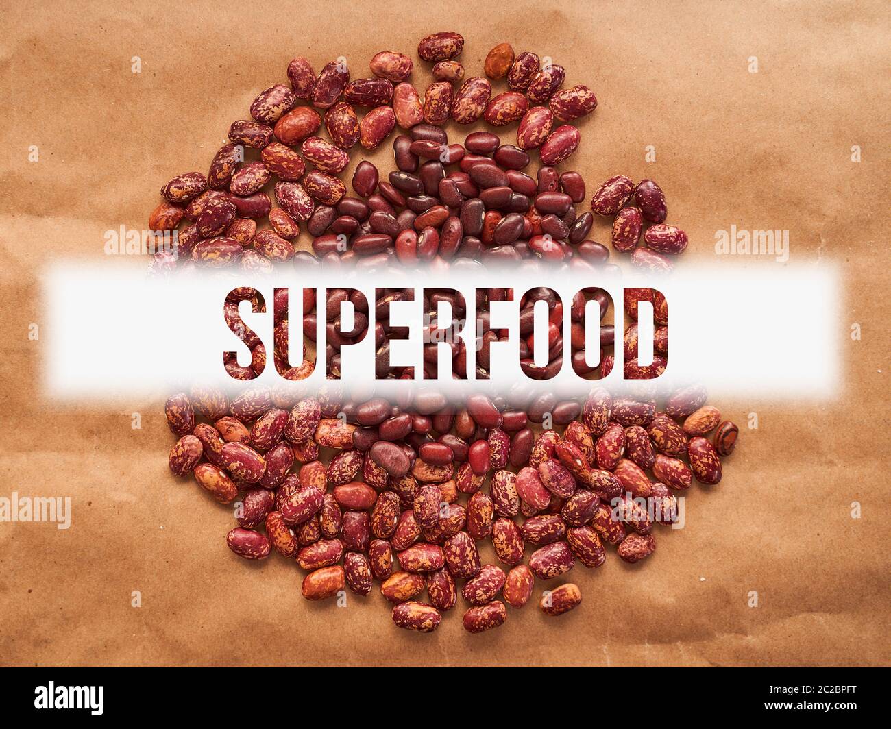 ed spotted beans are scattered on a brown background. Rectangle form ...