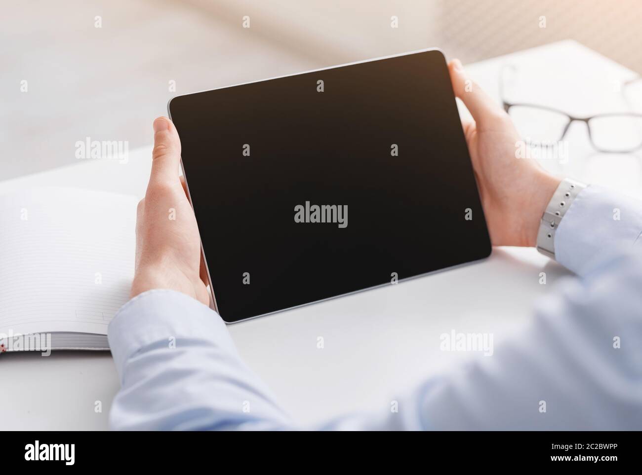 Work with client remotely. Hands of businessman holds digital tablet ...