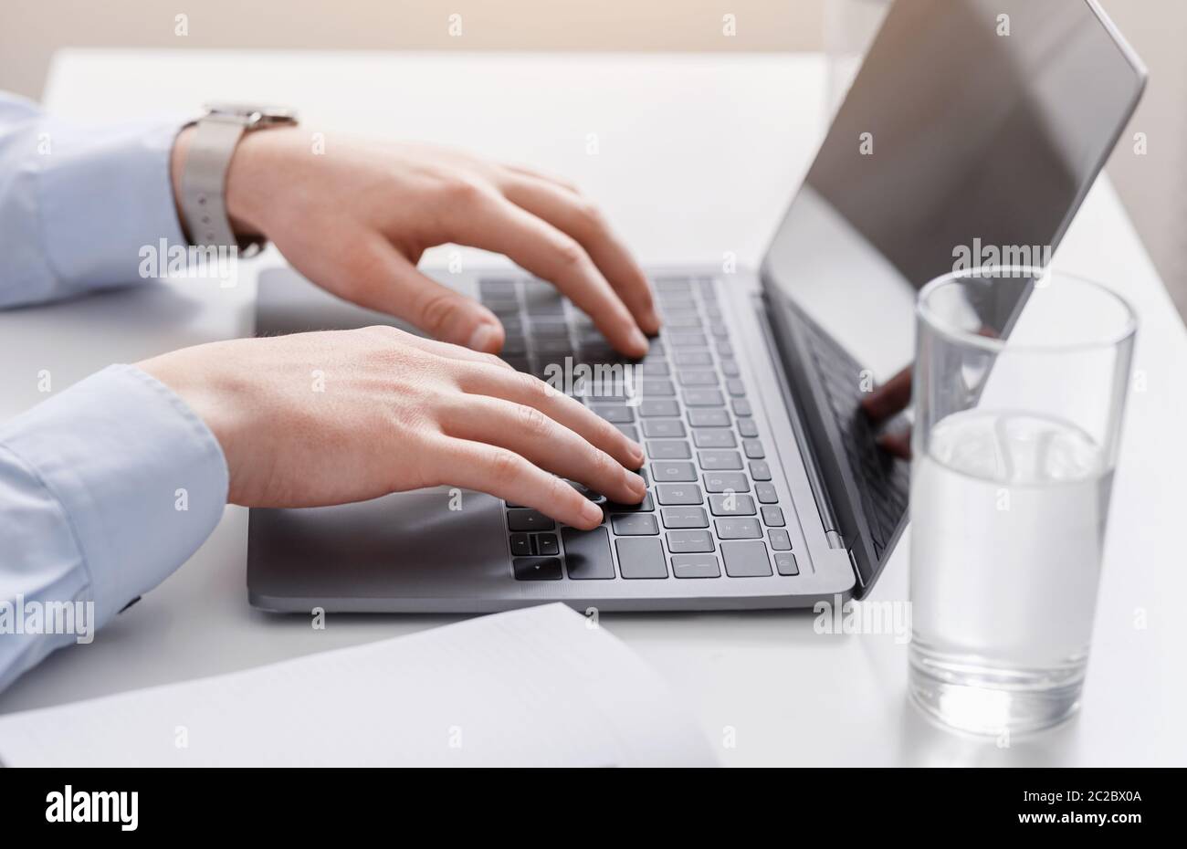 Work with documents from home. Man hands typing on laptop with blank ...
