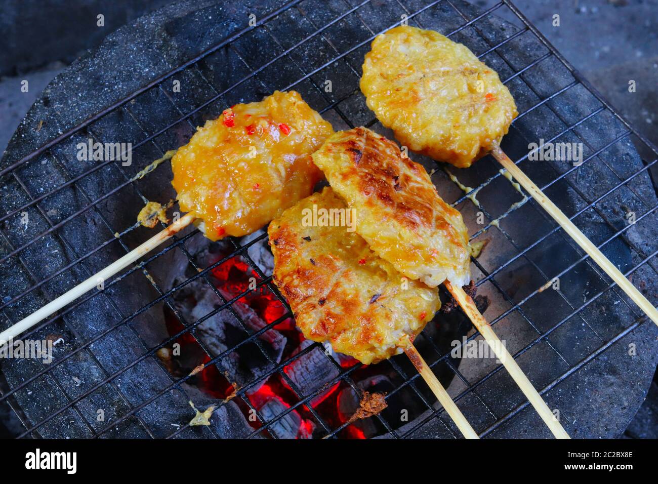 Grilled sticky rice coated with spicy egg sauce ready for serving ...