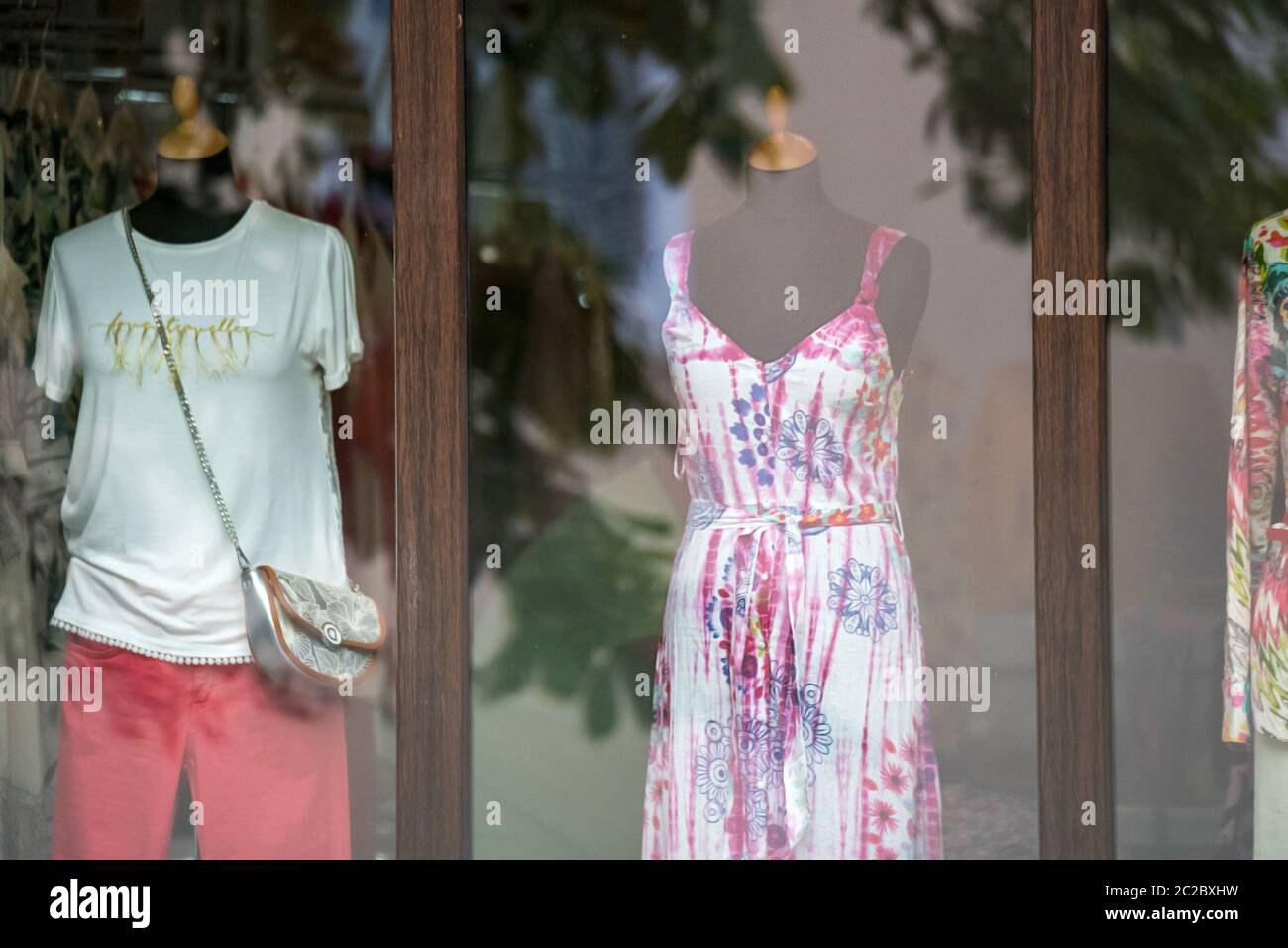 Women's clothes on store display. Storefront glass Stock Photo - Alamy