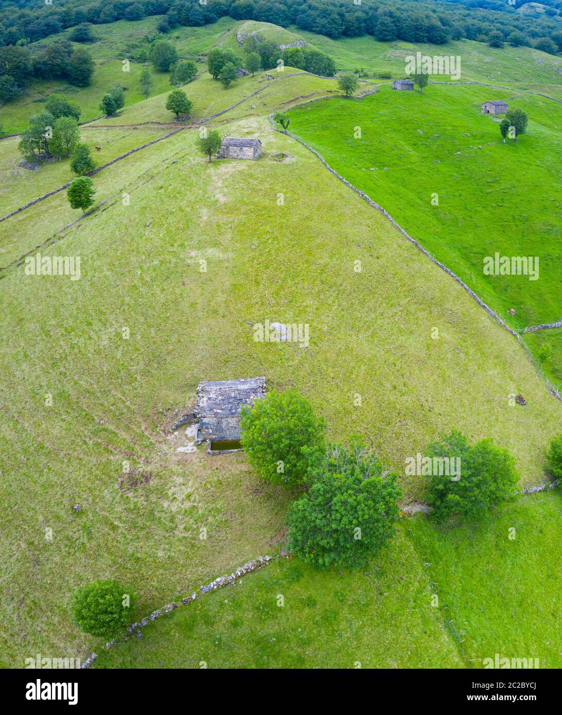 Aerial view with a drone of the spring landscape of pasiegas cabins and ...