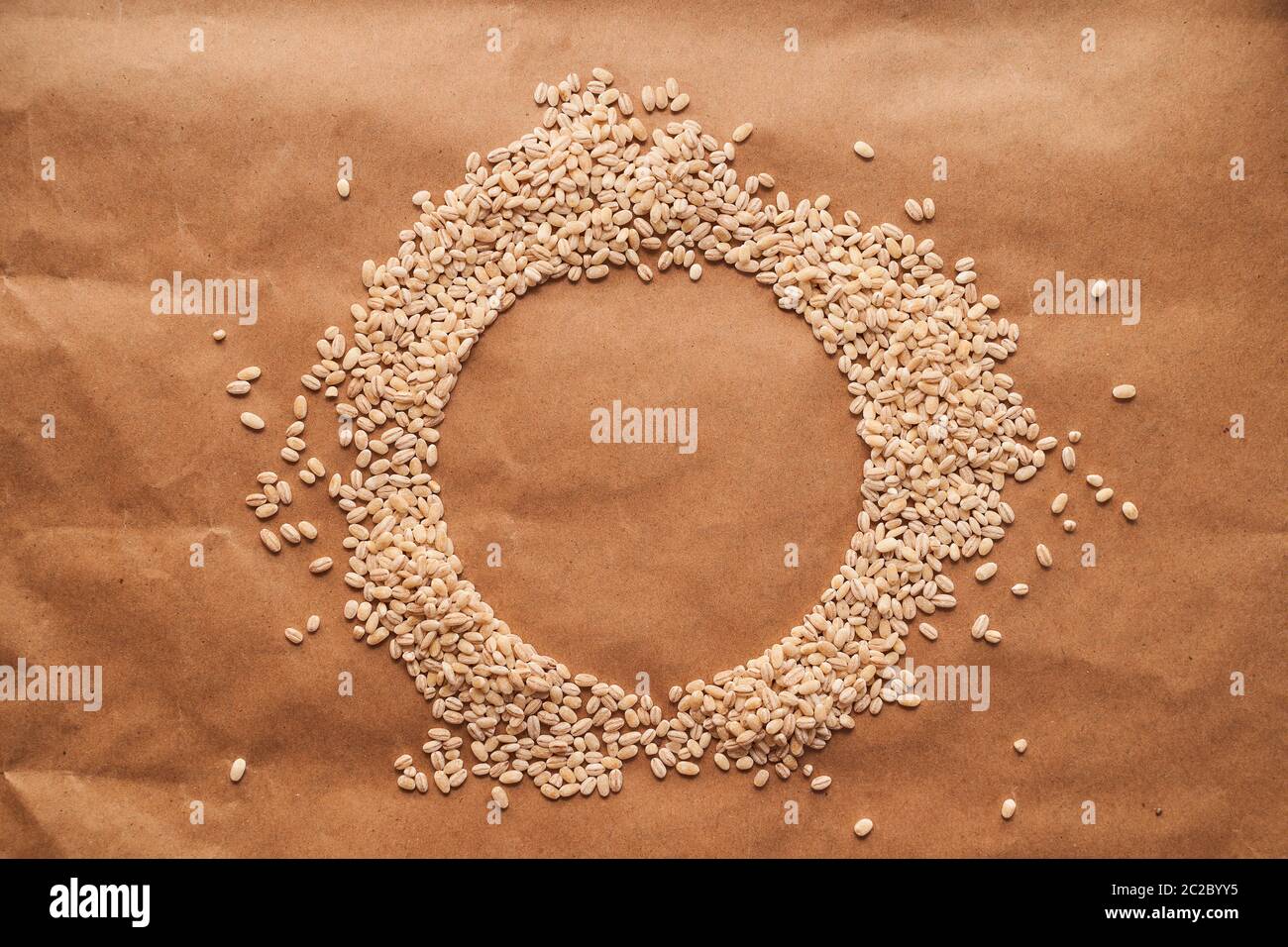 Oat croup in the shape of a circle lies on a cinnamon background Stock ...
