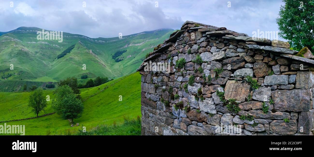 Spring landscape of pasiegas cabins and meadows in the Miera Valley in ...